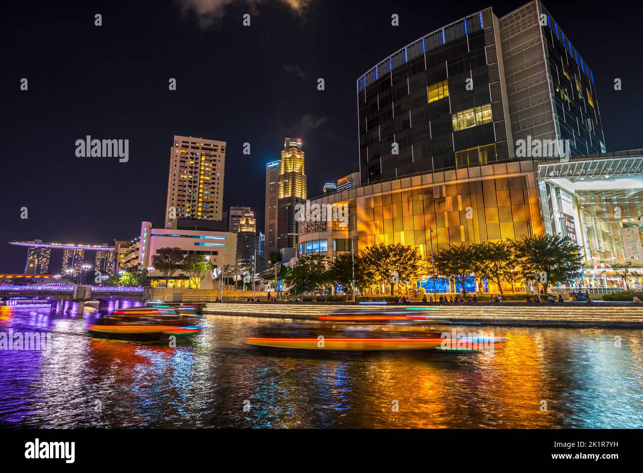 Clarke Quay on Singapore River illuminated by coloured lights with ...