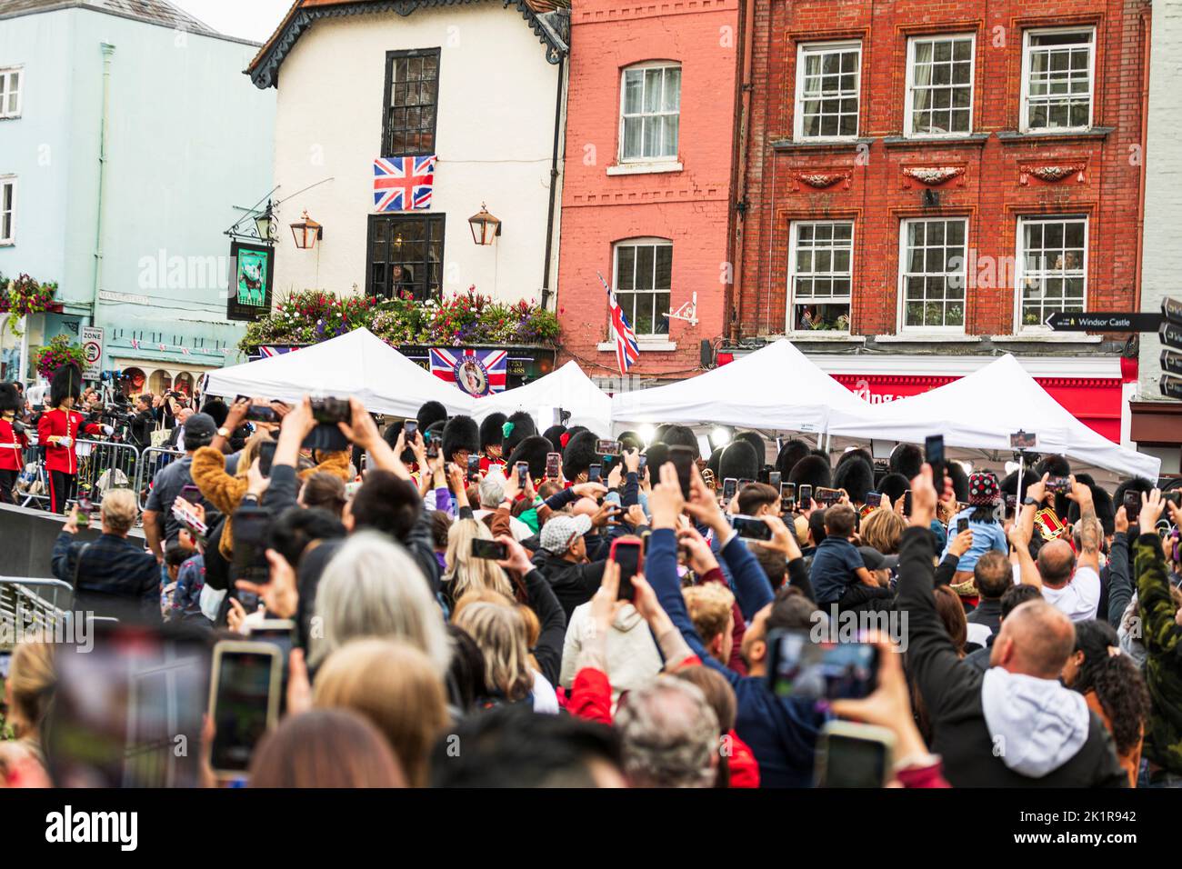 A crowd of people outside Windsor Castle watching the Royal Guards ...
