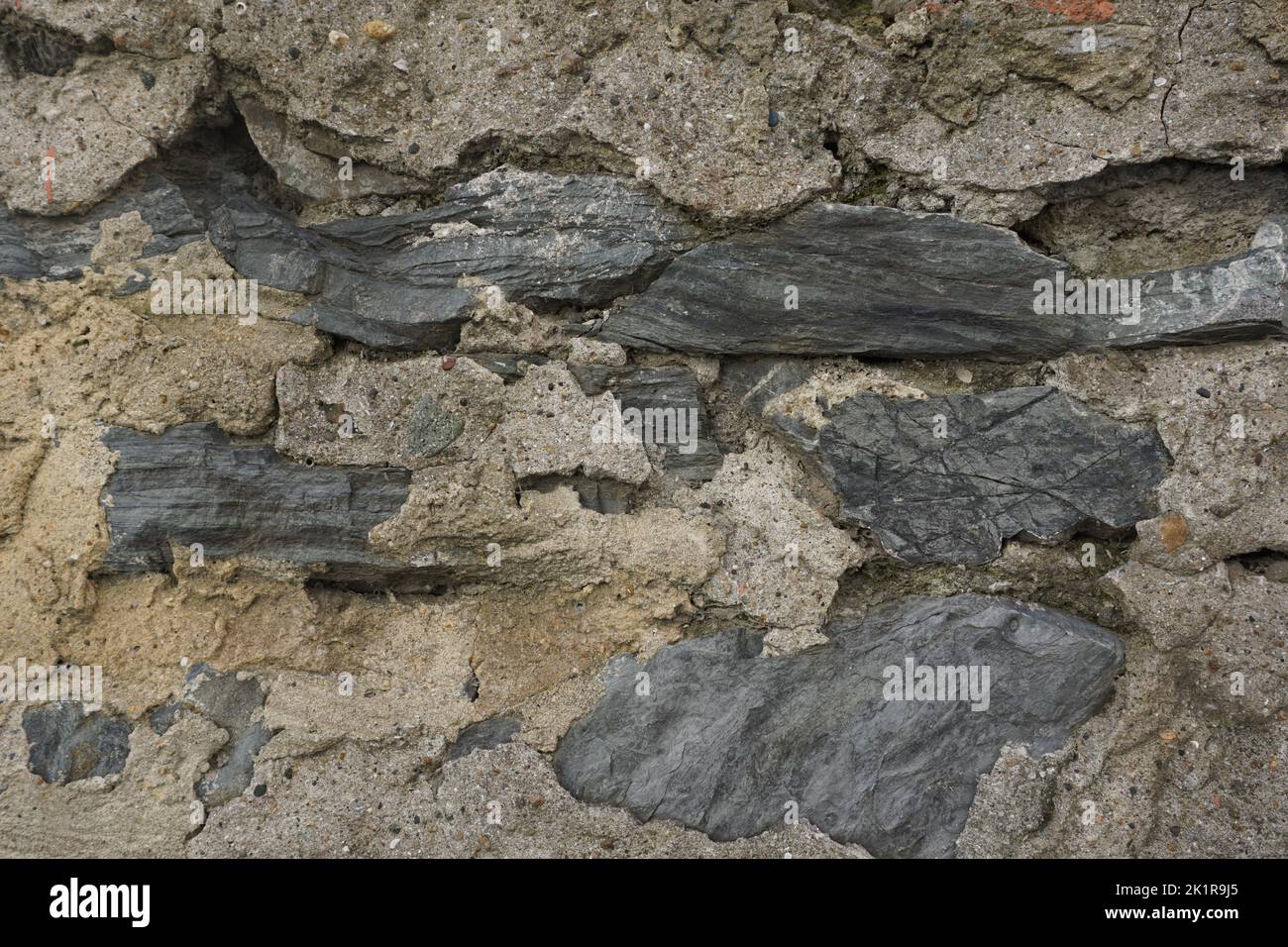 wall detail with stones visible through old plaster Stock Photo - Alamy