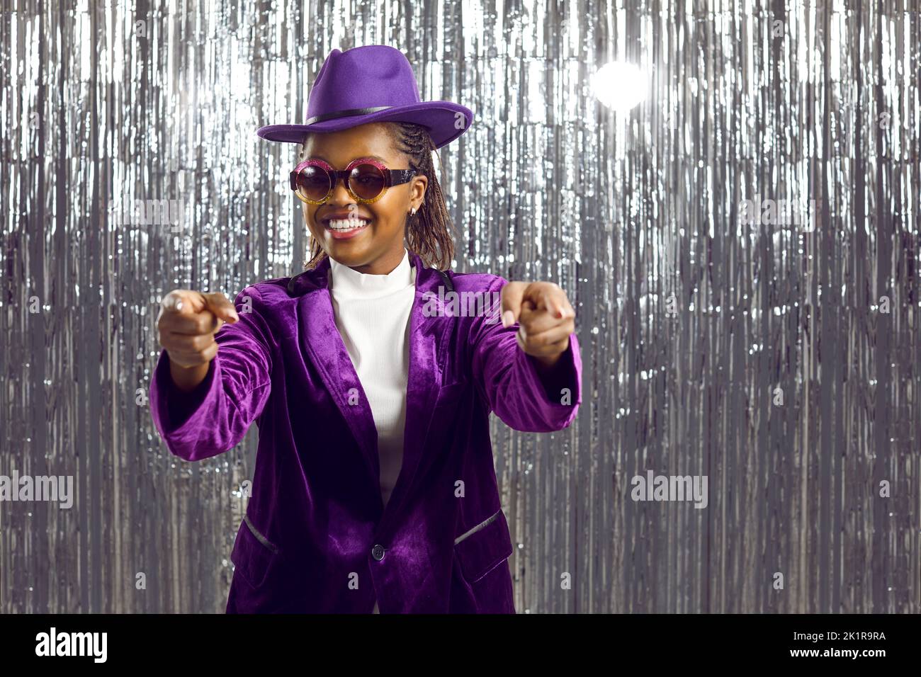 Smiling black woman entertainer point at screen Stock Photo - Alamy