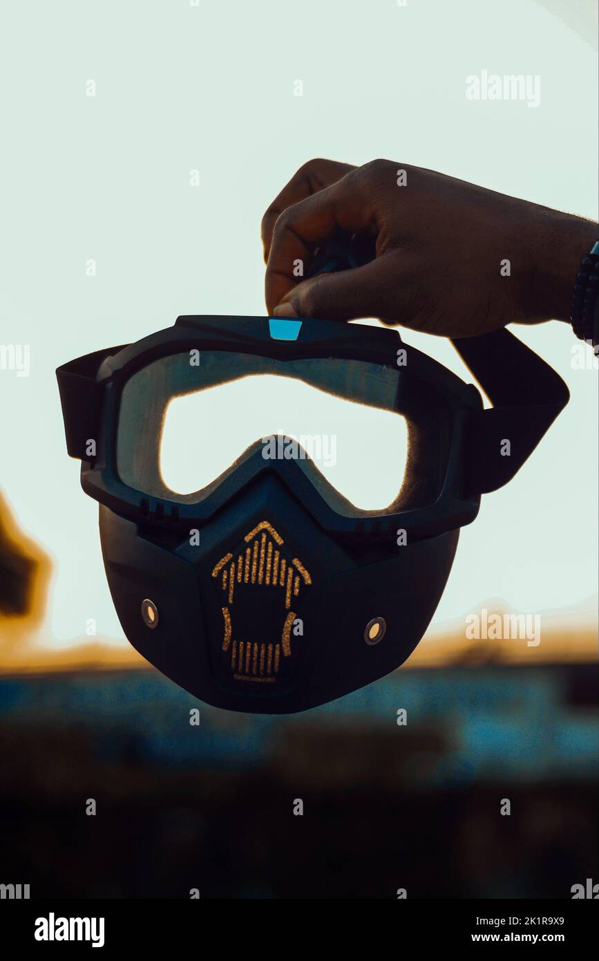 A vertical closeup of a hand holding a diving mask Stock Photo - Alamy