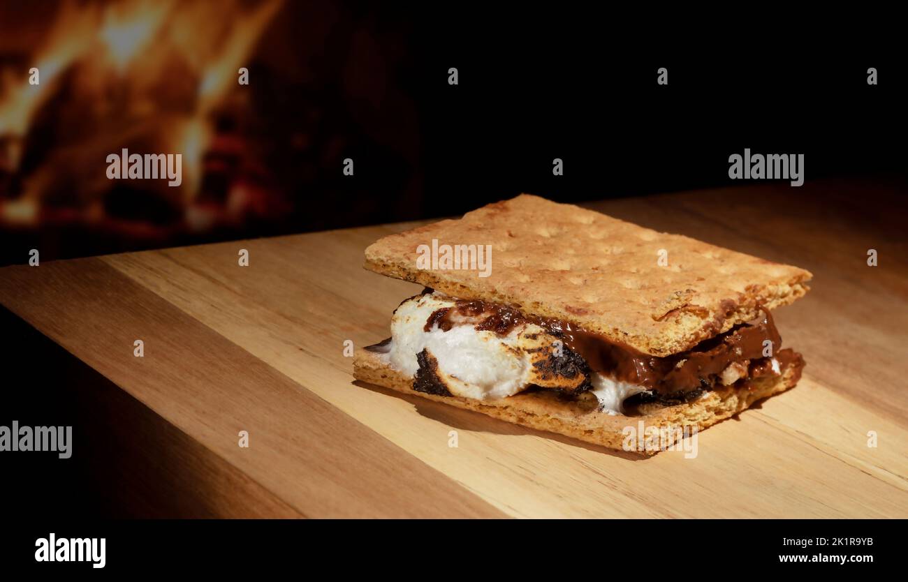 Smore just off the fire and cooling on a wood table Stock Photo - Alamy