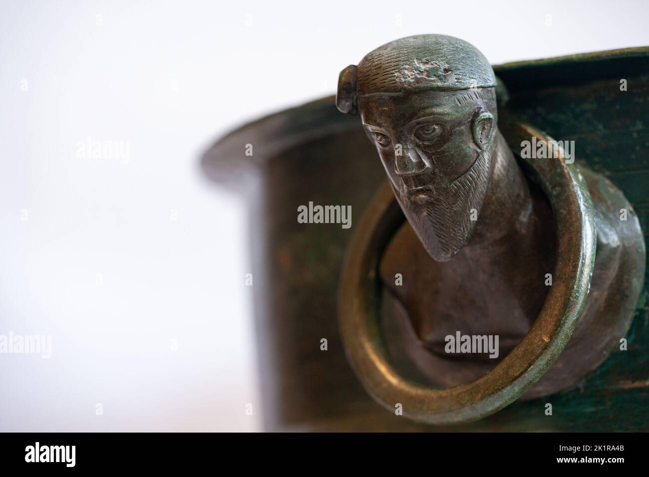 The cauldron is decorated by four cast heads of Germanic men wearing a ...