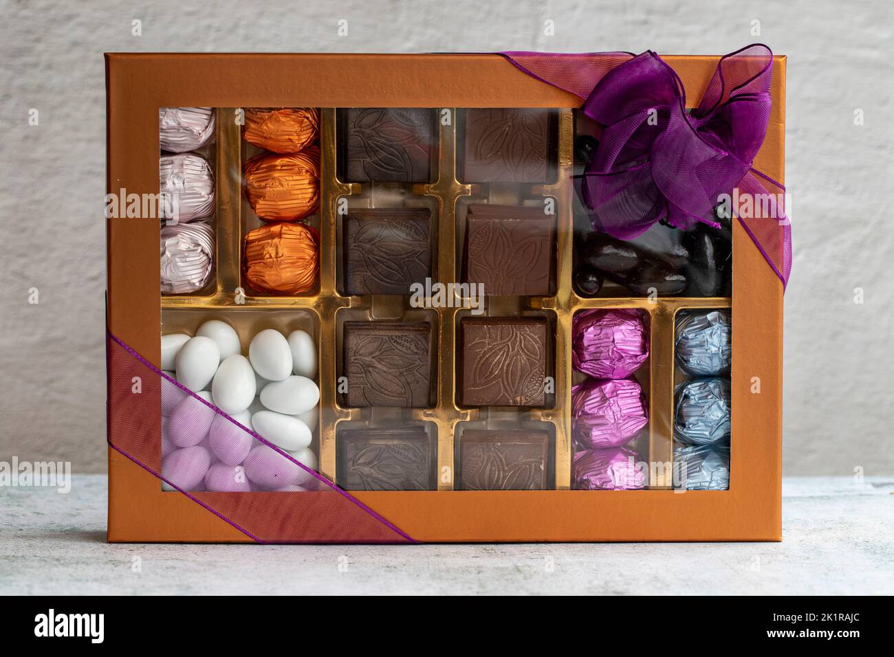 Packed gift chocolate. Packed chocolates on gray background. close up ...