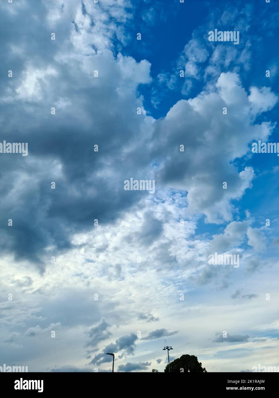Beautiful fluffy white beautiful cloud formations in a deep blue summer ...