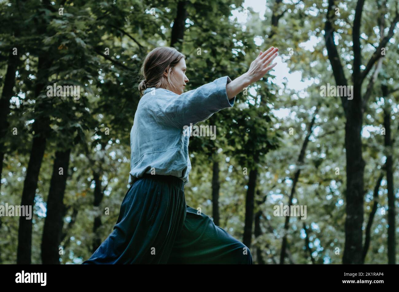 Woman doing healing movement in forest Stock Photo - Alamy