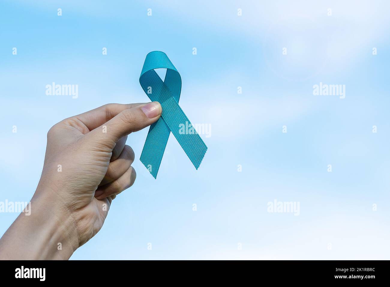 November Prostate Cancer Awareness month, man holding light Blue Ribbon ...