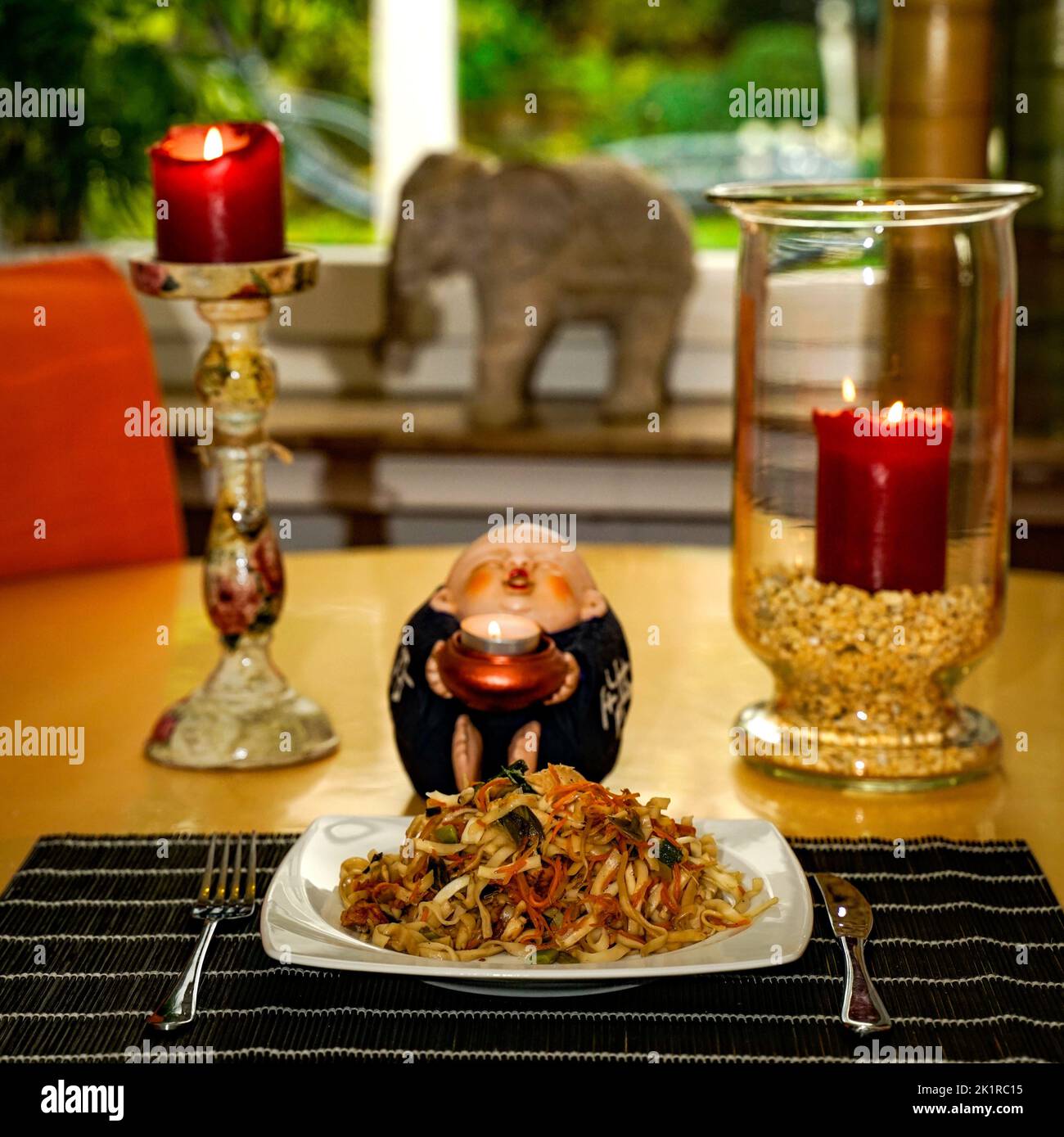 A closeup of fried Asian noodles with chicken, spring onions, carrots ...