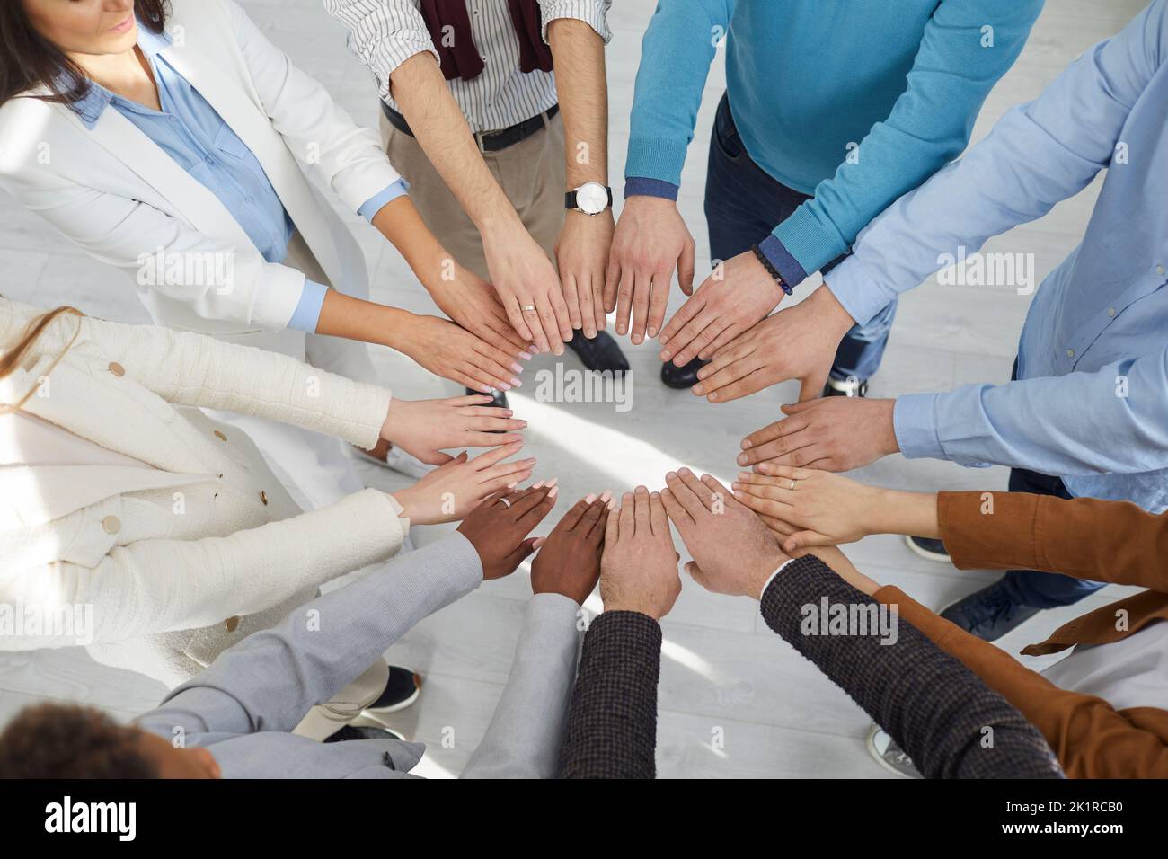 Top view multiracial team peoples outstretched hands standing in circle ...