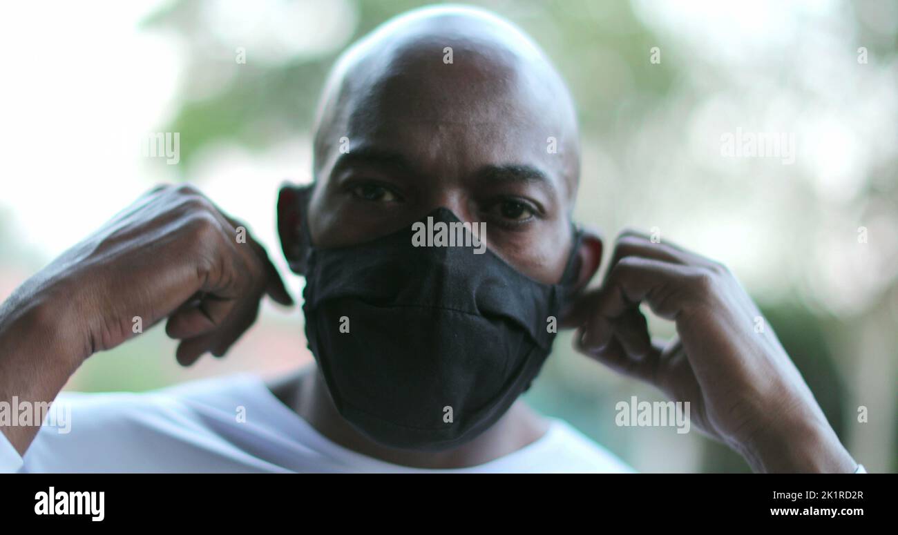African man putting face mask hi-res stock photography and images - Alamy
