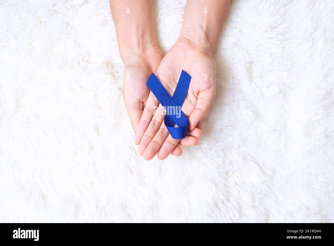 March Colorectal Cancer Awareness Month Man Holding Dark Blue Ribbon