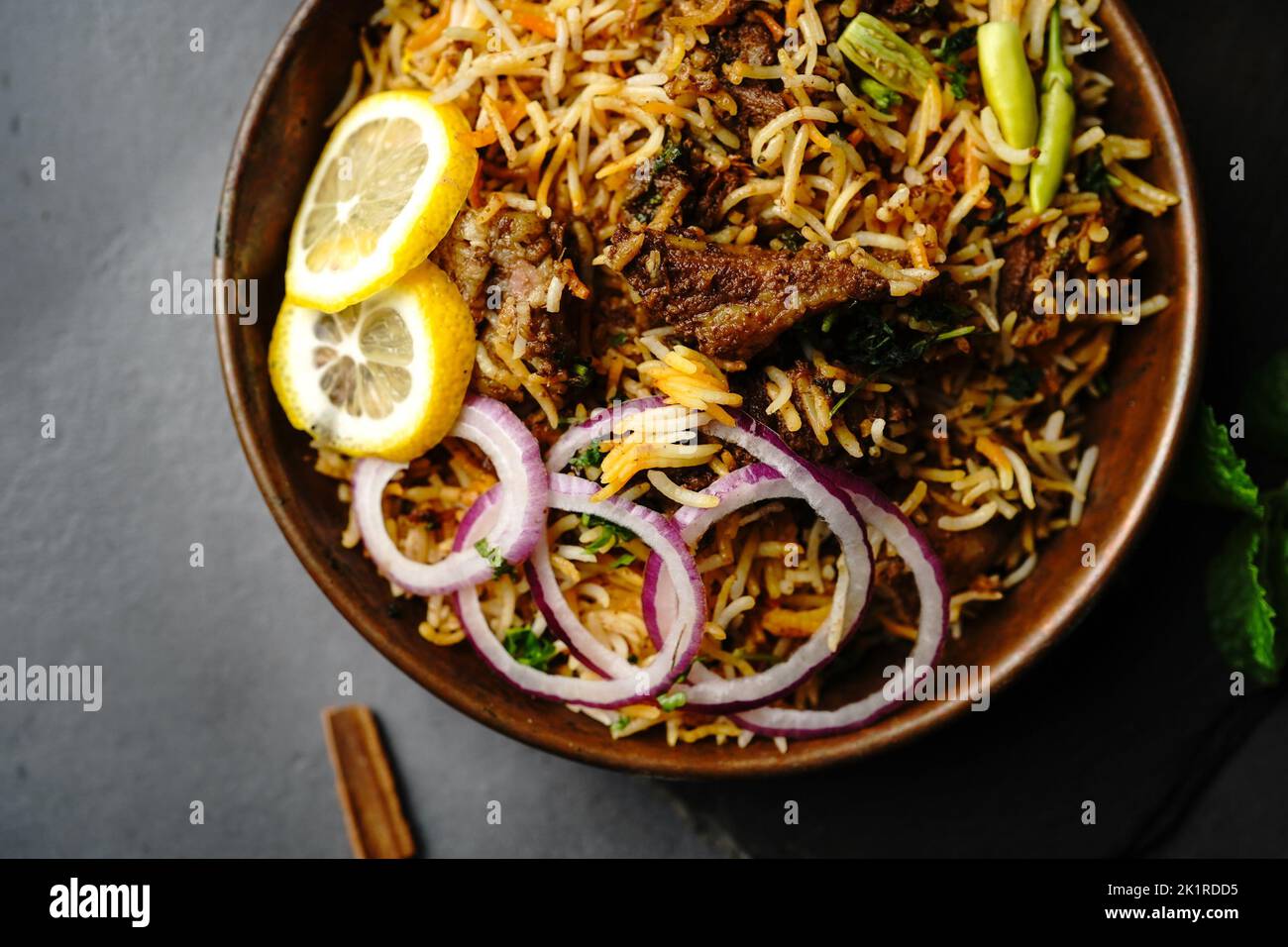 Hyderabadi Mutton goat biryani served with yogurt raita on moody ...