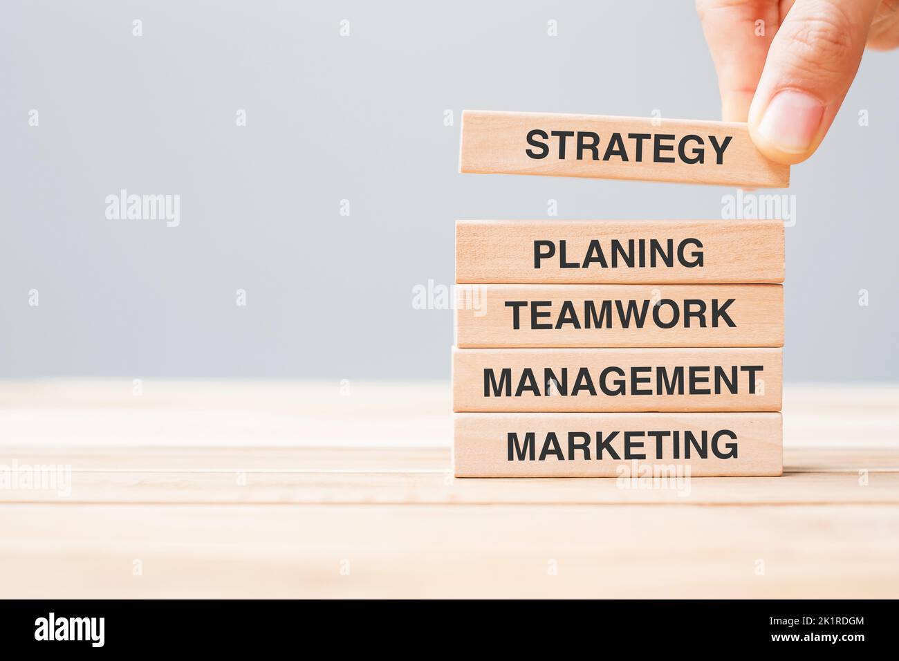 Business man hand holding wooden block with STRATEGY, PLANNING ...