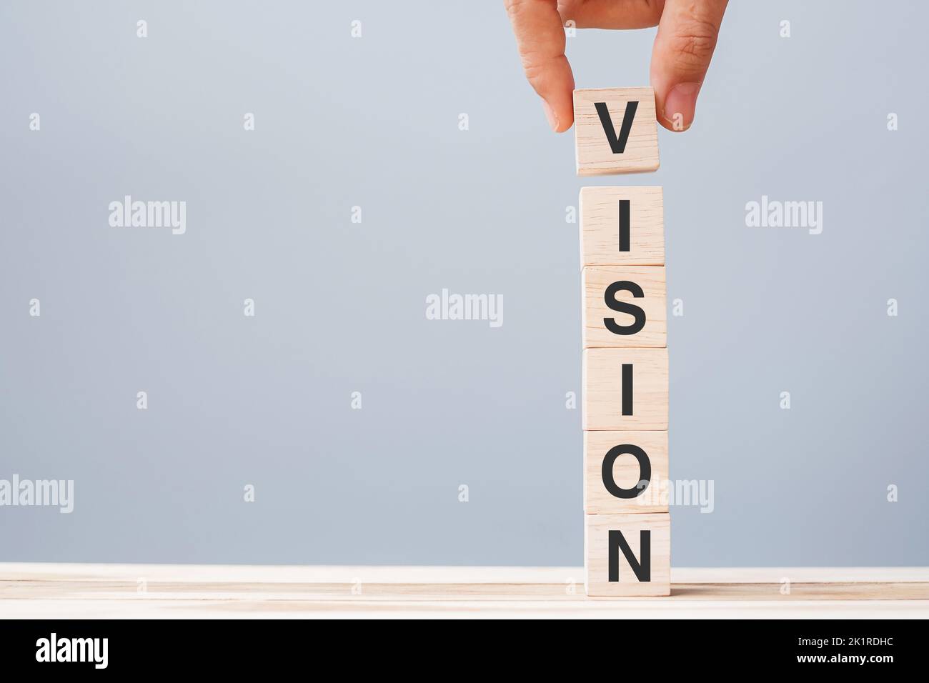 Business man hand holding wooden cube block with VISION business word ...