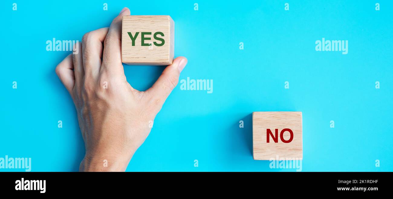 Hand choosing Yes or No block. Answer, question and decision concept ...