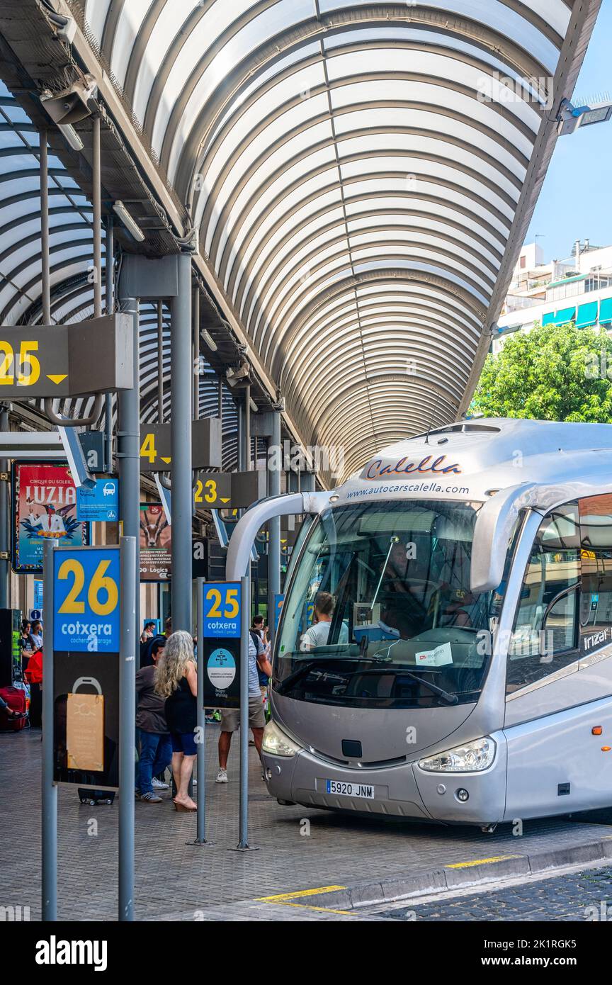 Barcelona Nord Bus Station. People boarding a gray bus which is parked ...