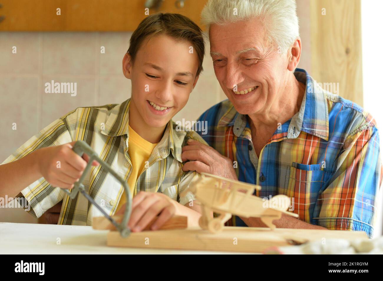Grandfather and his grandson made an airplane model Stock Photo - Alamy