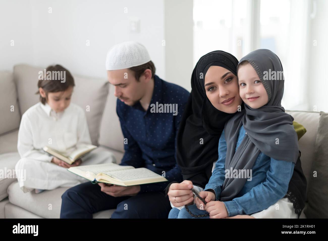 Traditional muslim family parents with children reading Quran and ...