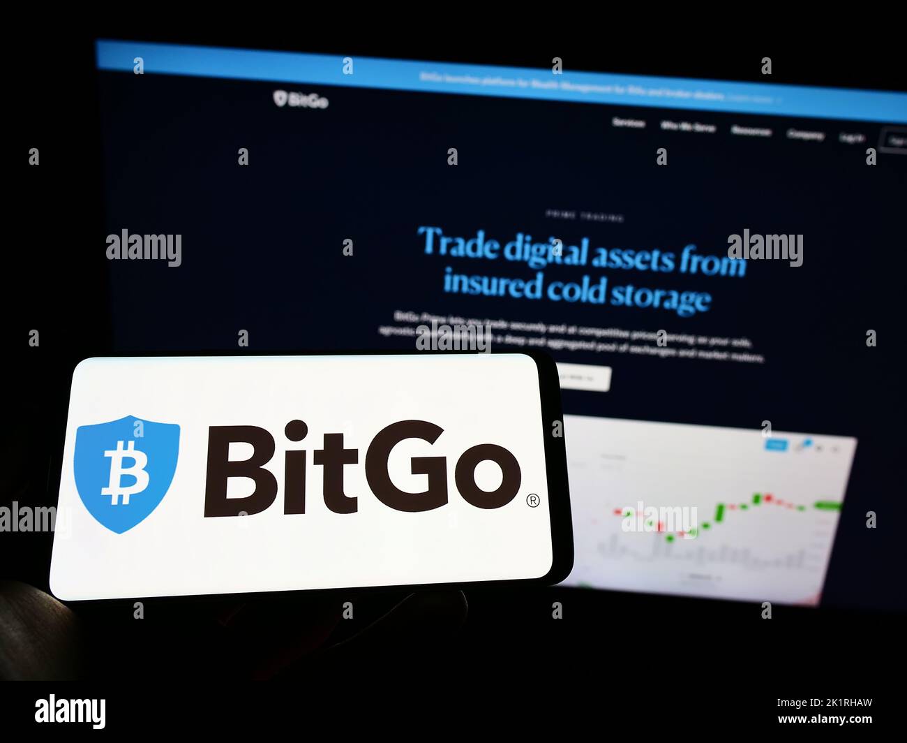 Person holding mobile phone with logo of American digital assets ...