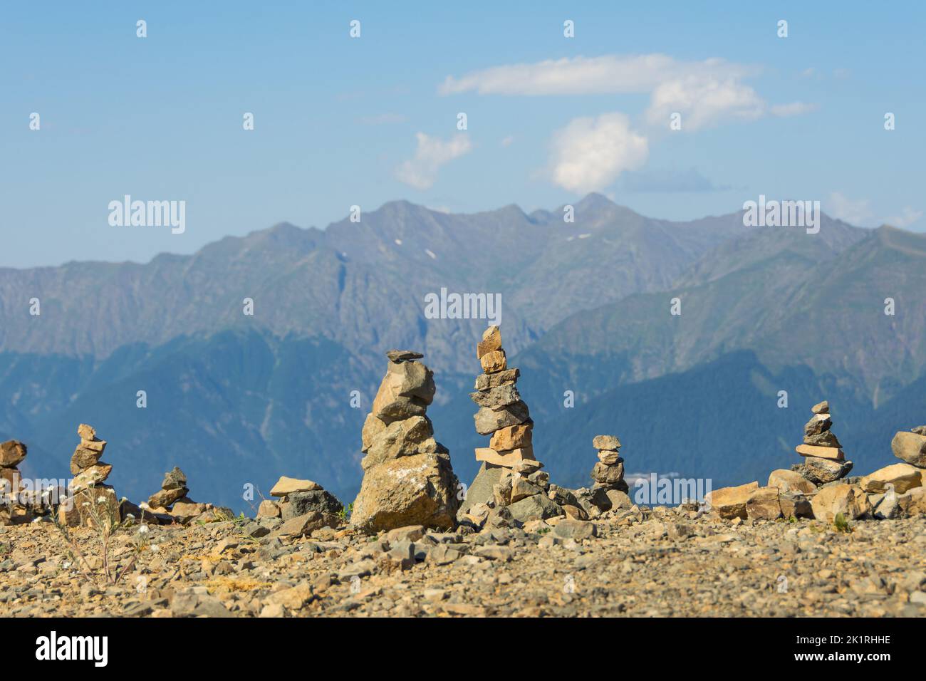 Pyramids of stones is built on a mountain pass. In the background ...