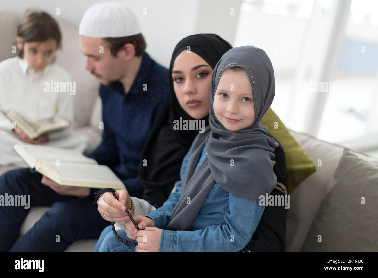 Traditional muslim family parents with children reading Quran and ...