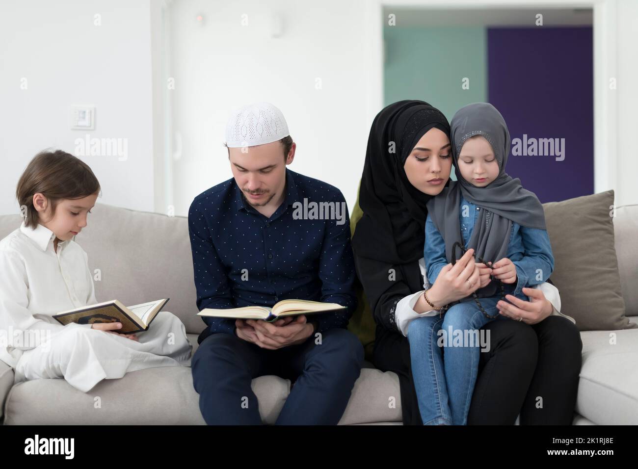 Traditional muslim family parents with children reading Quran and ...