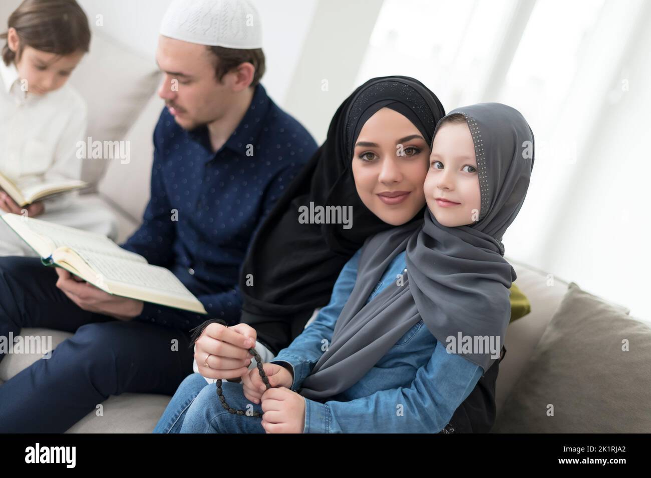 Traditional muslim family parents with children reading Quran and ...