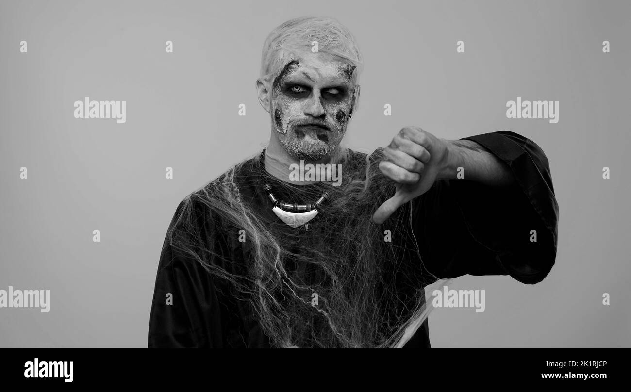 Sinister man in carnival costume of Halloween crazy zombie with bloody ...