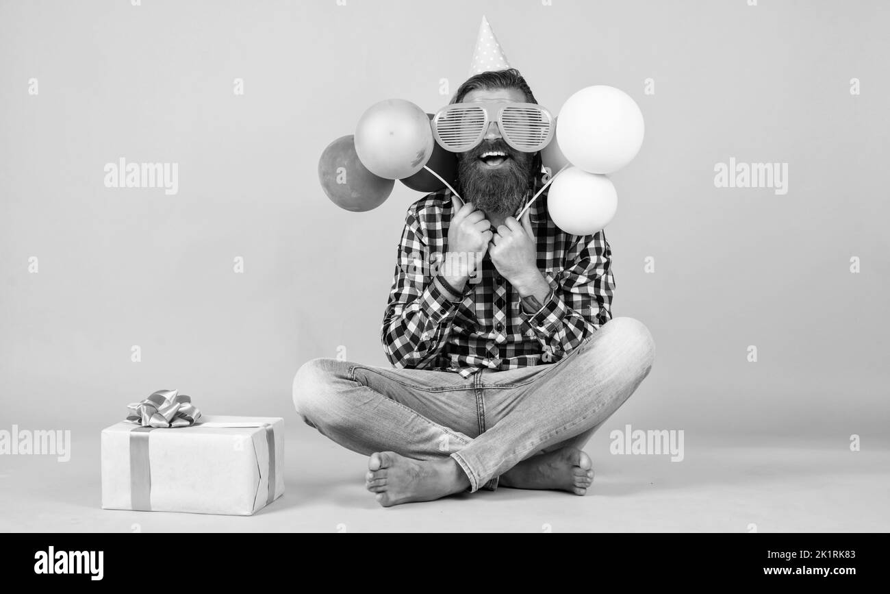 surprise. happy man holding colorful helium balloons. hipster smiling ...