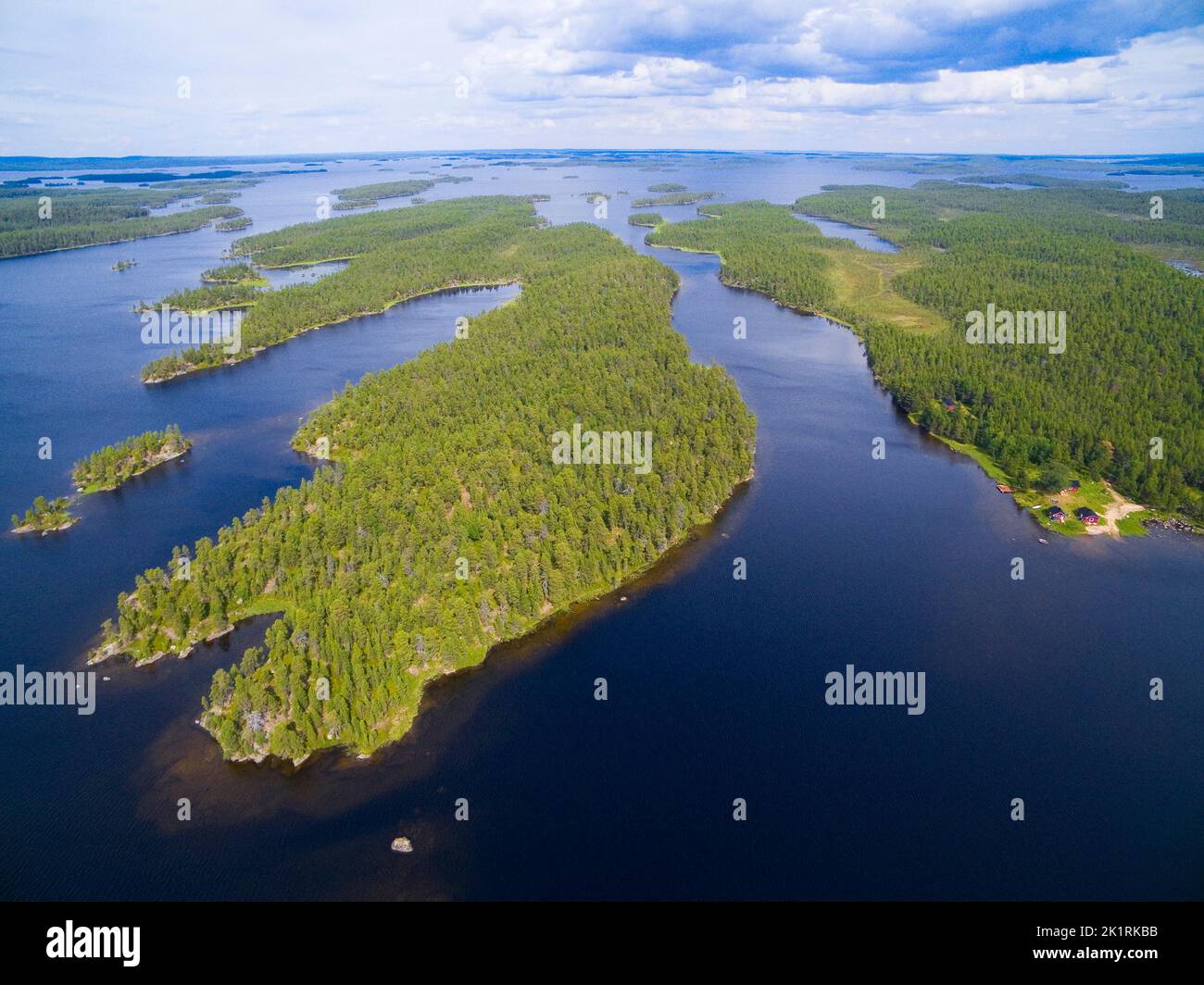 Aerial view of islands and traditional wooden houses on shore of Inari ...