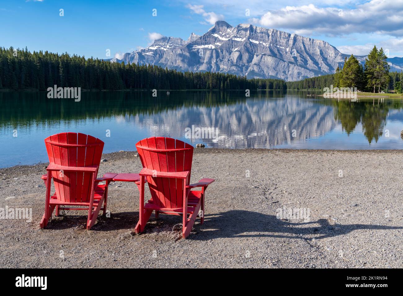 Two Jack Lake with the iconic red adirondack chairs at the shoreline in ...