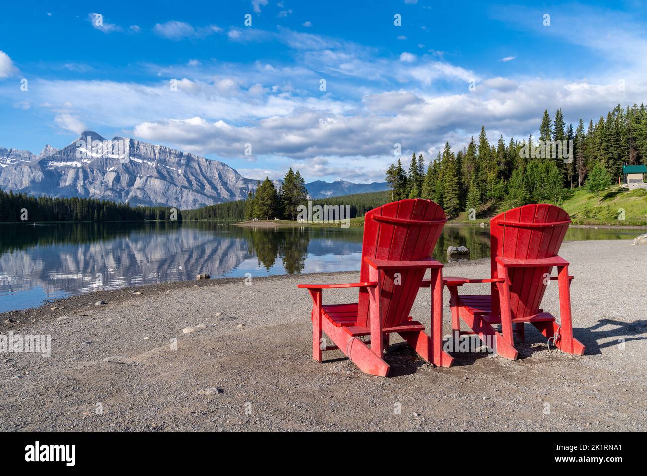 Two Jack Lake with the iconic red adirondack chairs at the shoreline in ...