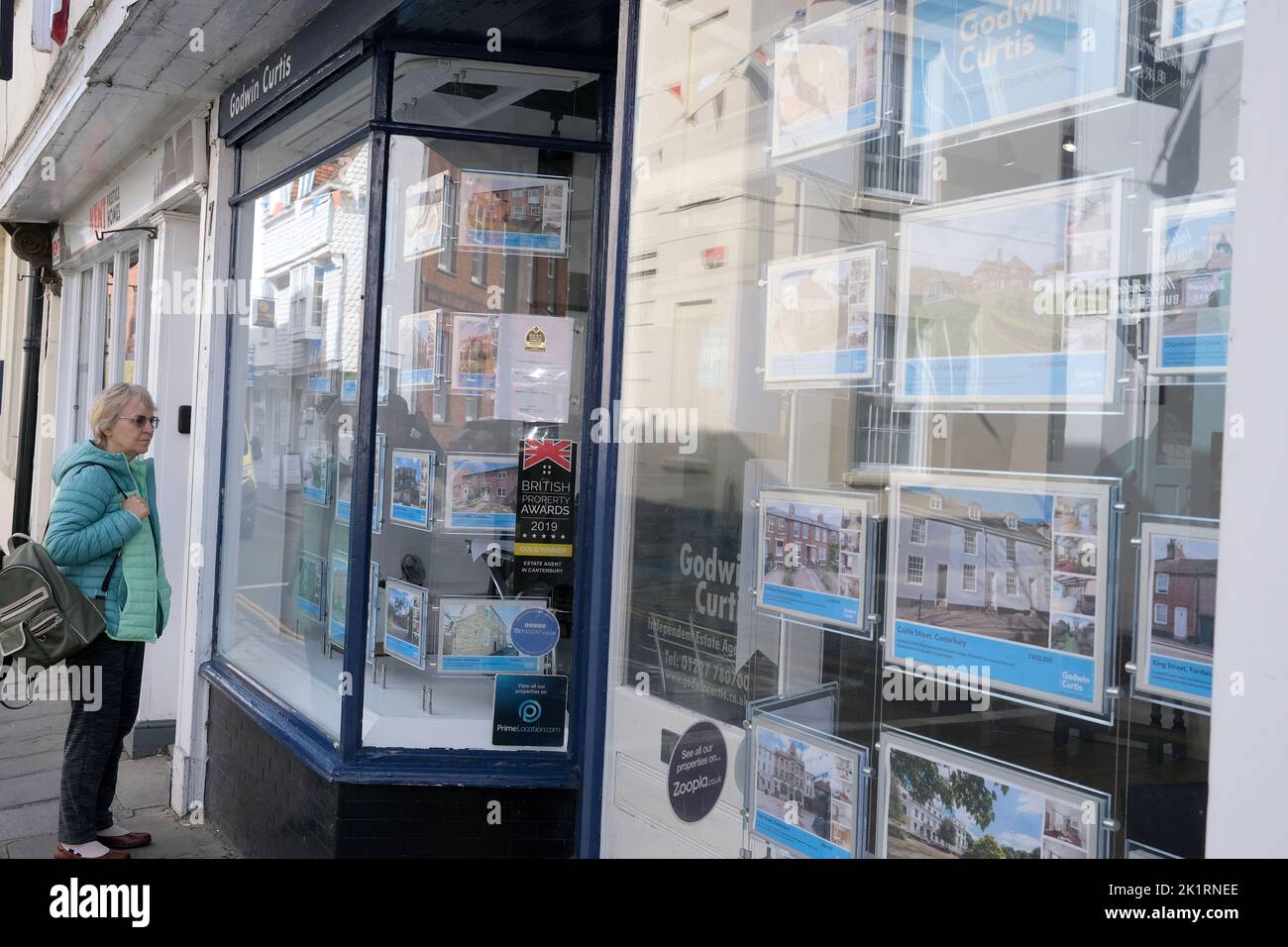 lady looking at the window display in the estate agents shop in castle ...