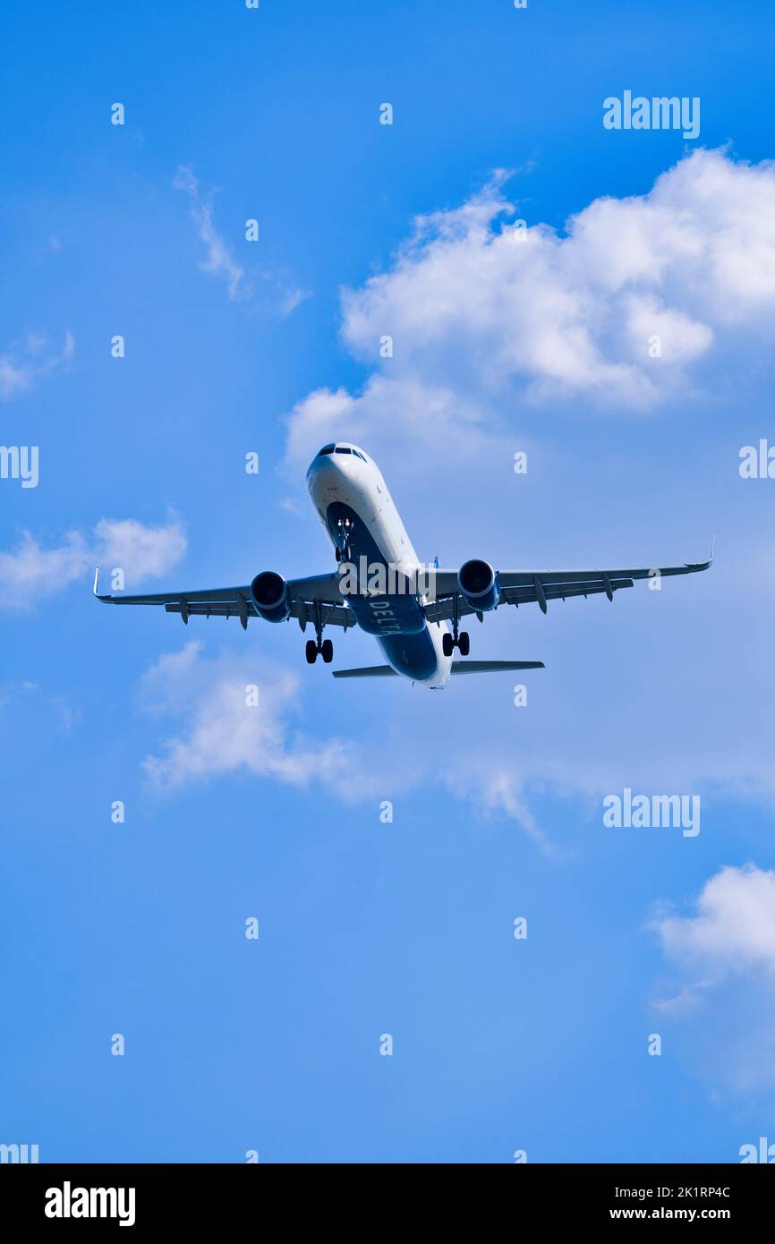 A vertical shot of an airplane flying overhead Stock Photo - Alamy