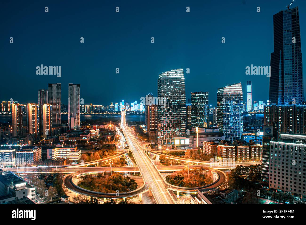 An aerial view of cityscape Wuhan surrounded by buildings in evening ...