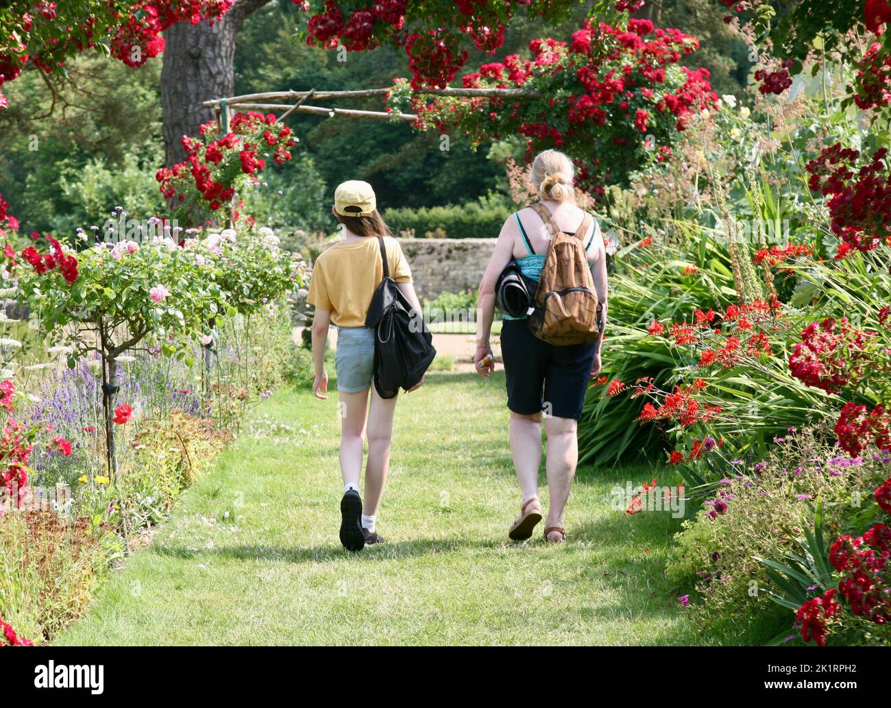 A senior lady and her granddaughter take a walk in the garden Stock ...