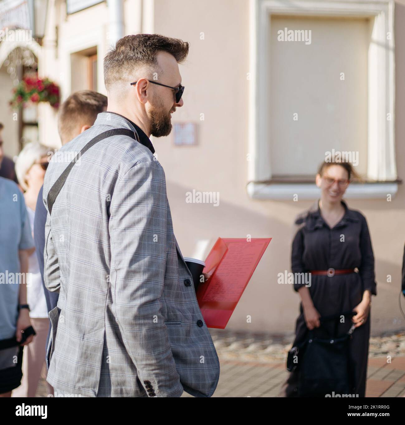 male guide standing among a group of tourists Stock Photo - Alamy