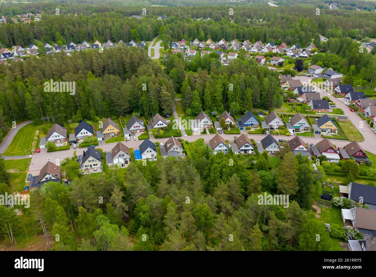 A bird's eye view of residential houses surrounded by forests Stock ...