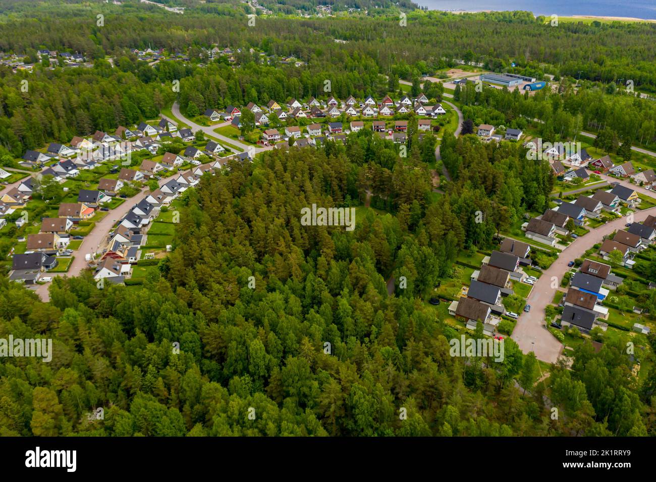 A bird's eye view of residential houses surrounded by forests Stock ...