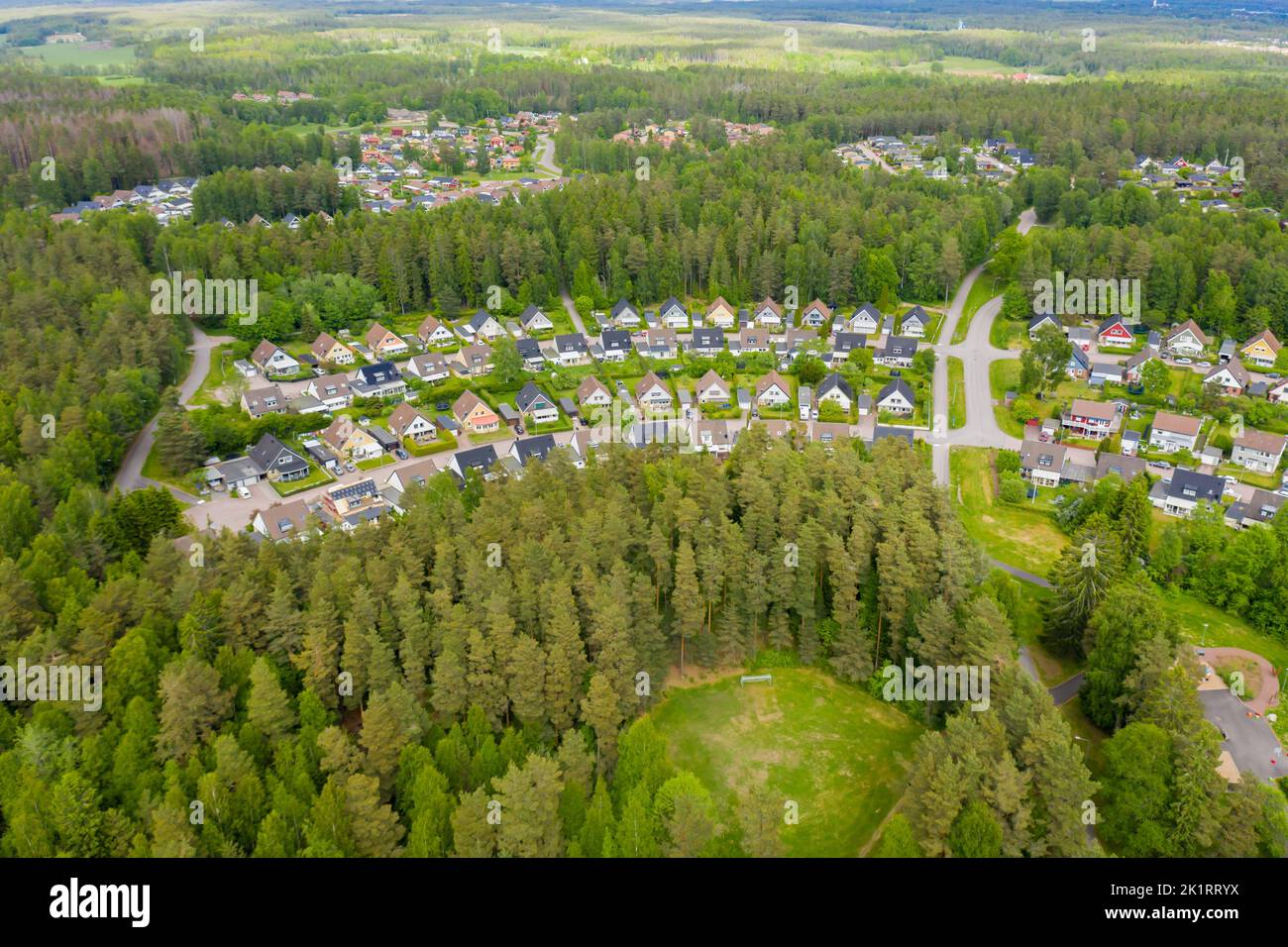 A bird's eye view of residential houses surrounded by forests Stock ...