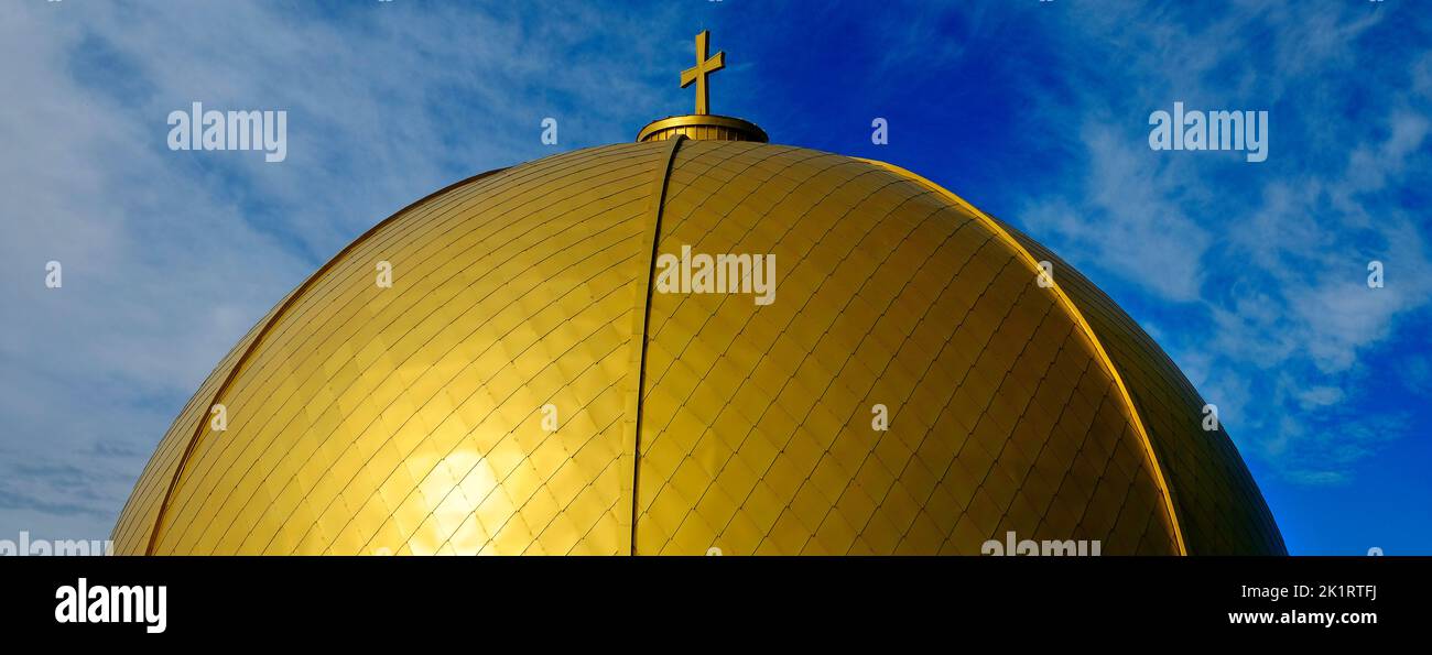 Gold dome on a christian church with cross and blue sky clouds in the ...