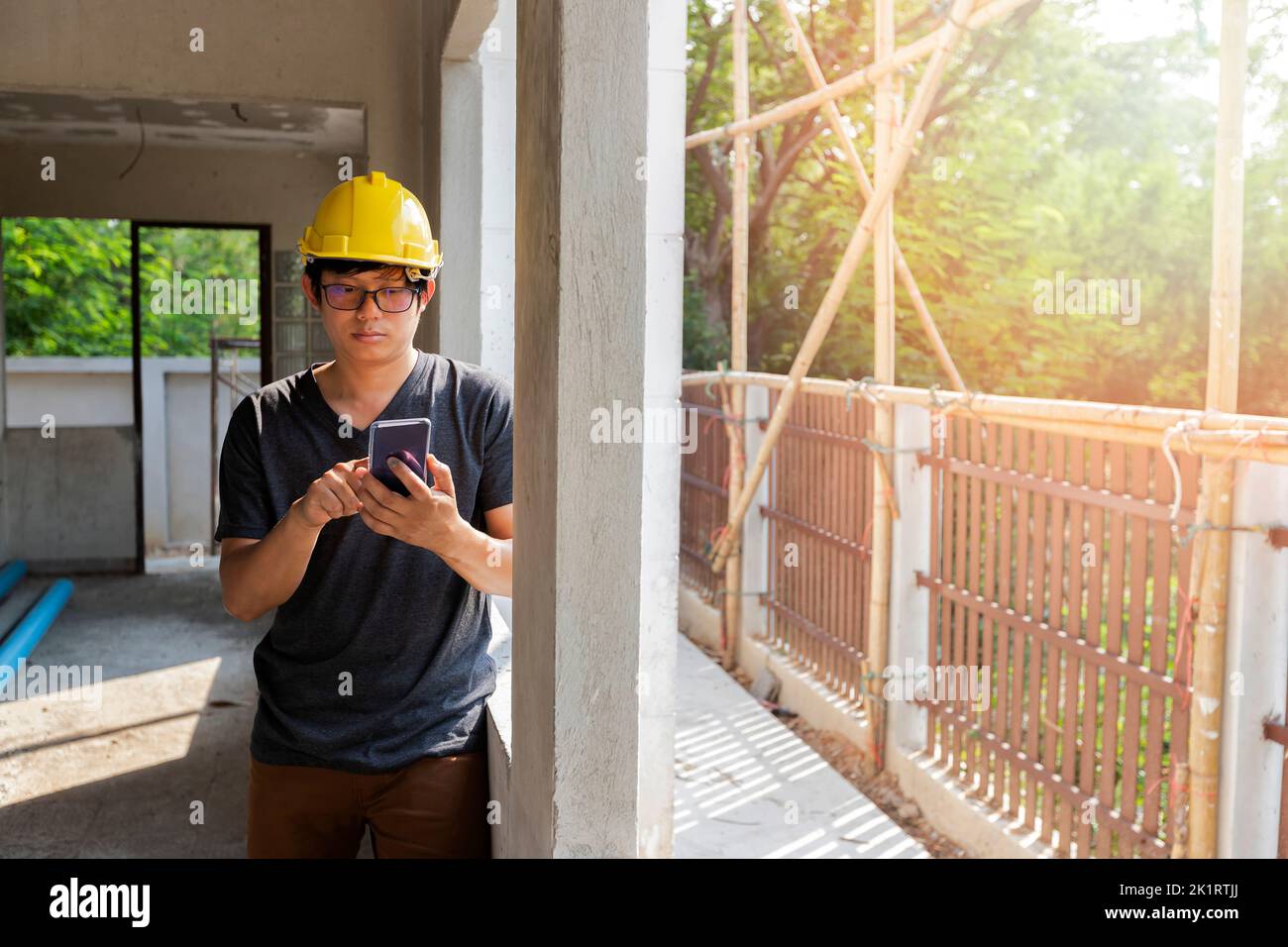 Engineer or Architect using cell phone in building construction site ...