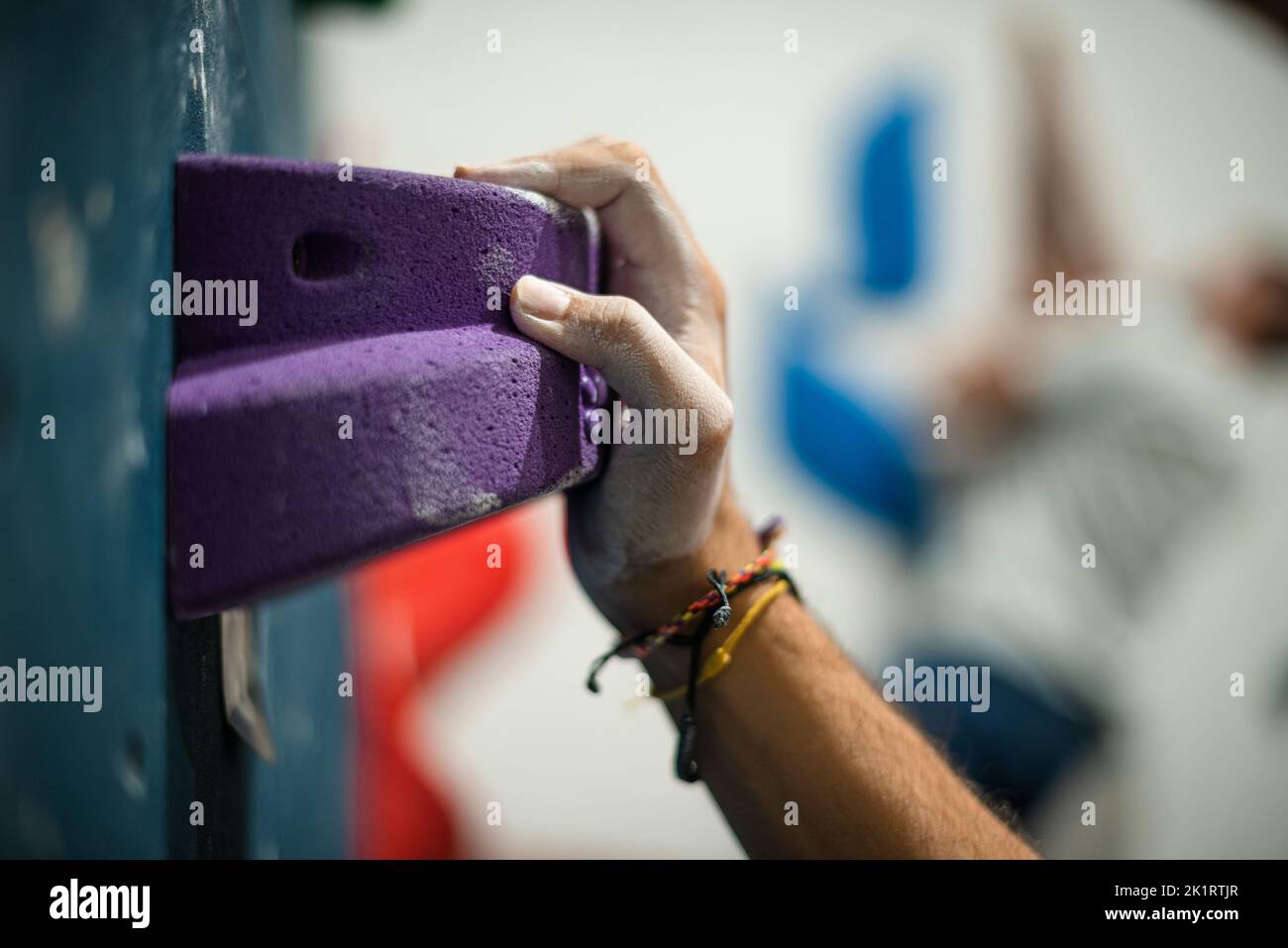 Hand holding on to a climbing hold on a climbing wall Stock Photo - Alamy