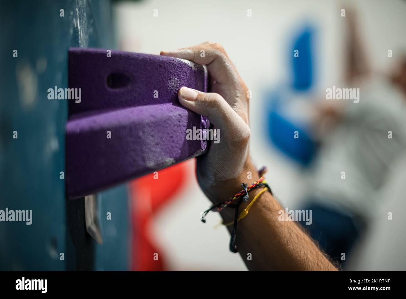 Hand holding on to a climbing hold on a climbing wall Stock Photo - Alamy