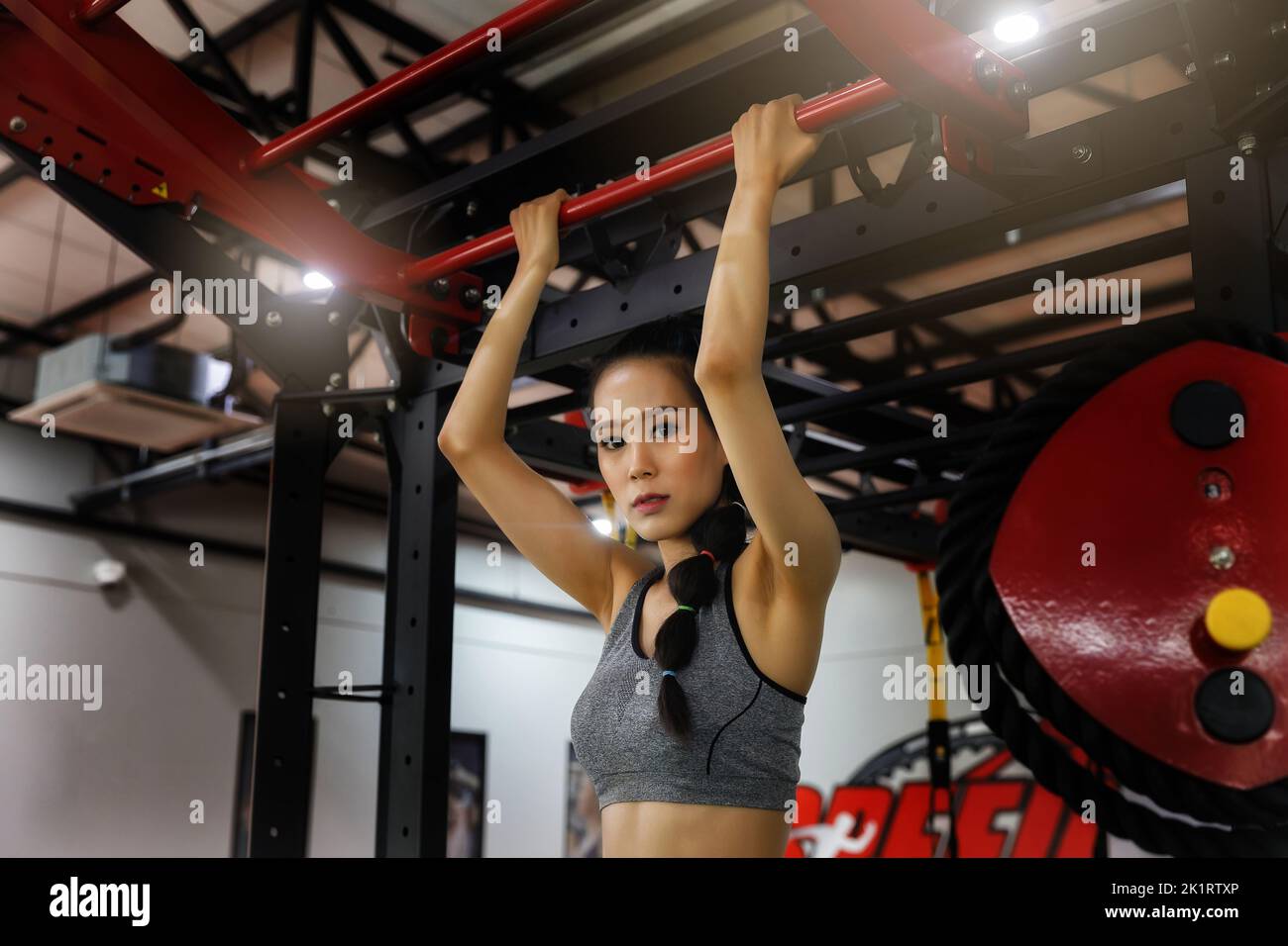 Fitness woman exercising on chin-up bar. Athlete girl doing chin-ups ...