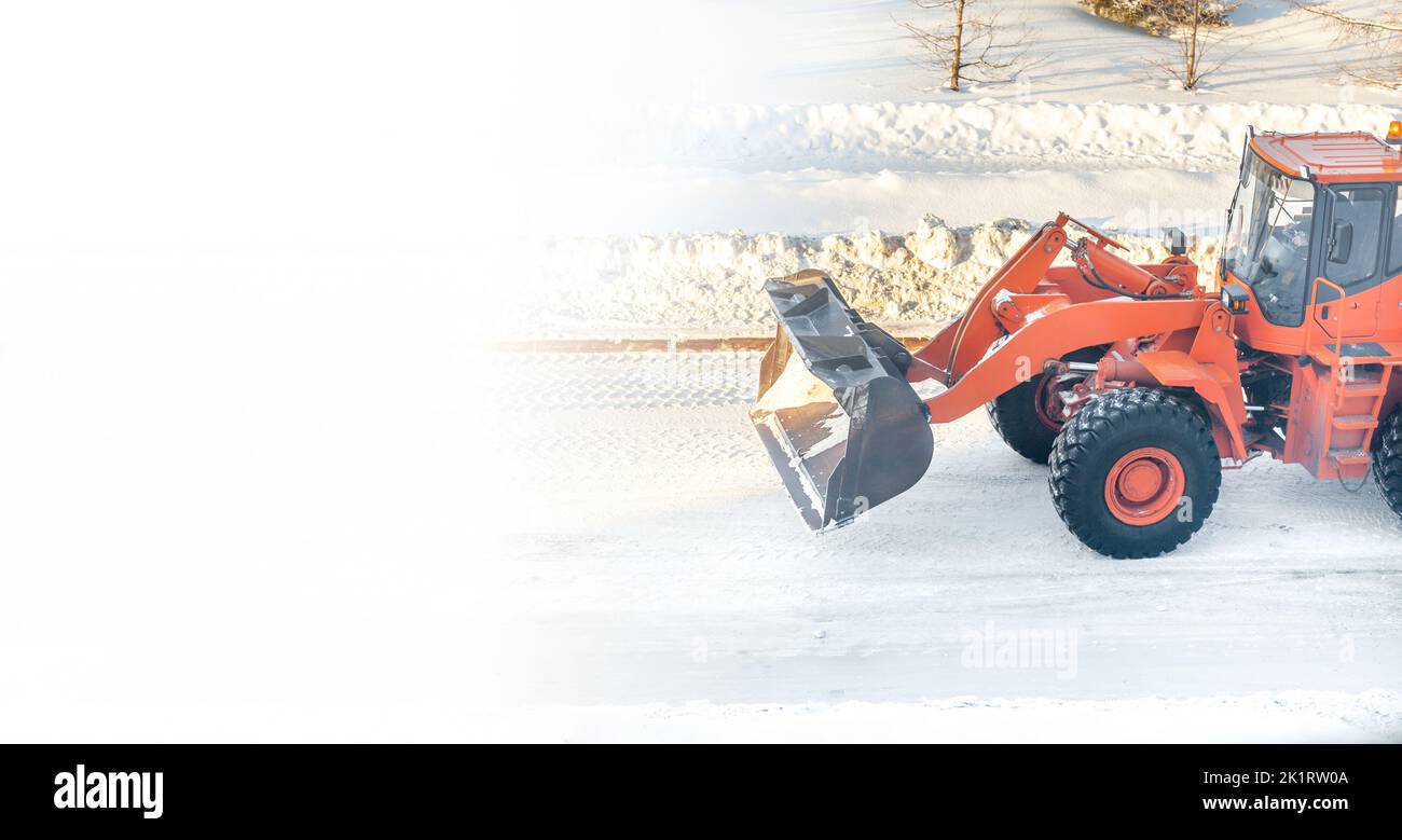 Big orange tractor removes snow from the road and clears the sidewalk ...