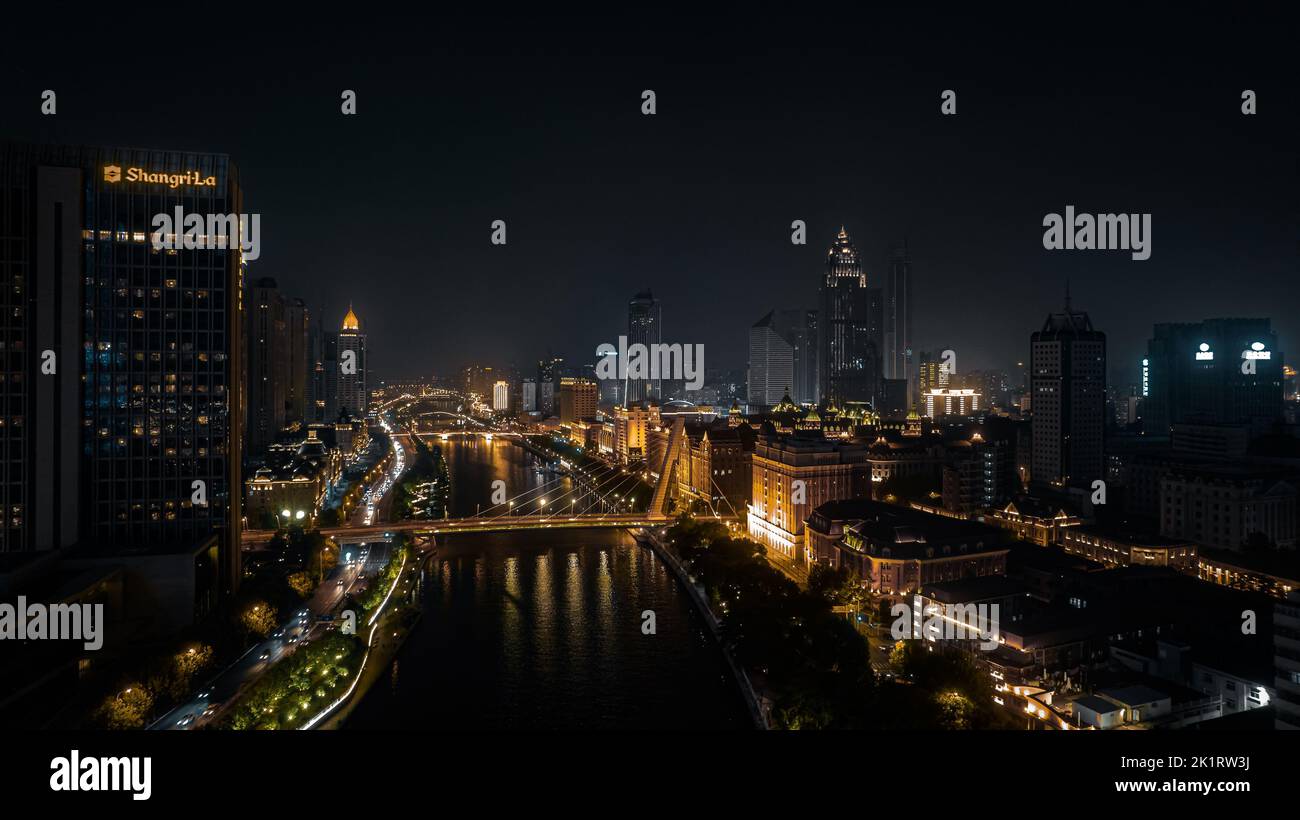 Aerial night view of of the city over Haihe River in Tianjin, China ...