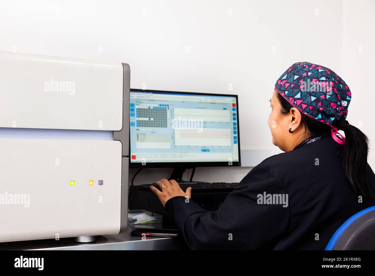 Female Scientist Working At The Laboratory With A Thermal Cycler Real Time Polymerase Chain