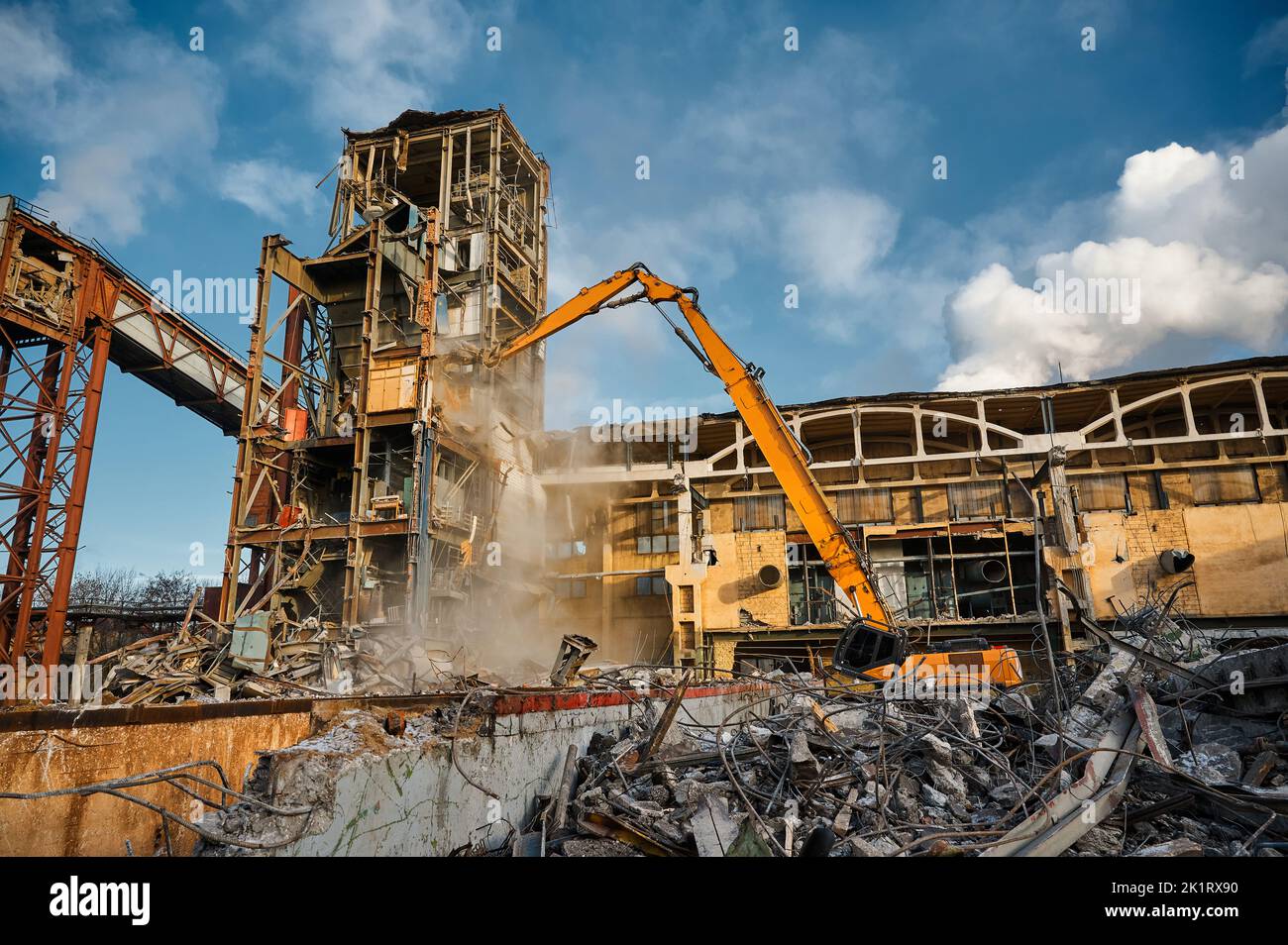 Destroyer excavator with large manipulator near factory Stock Photo - Alamy
