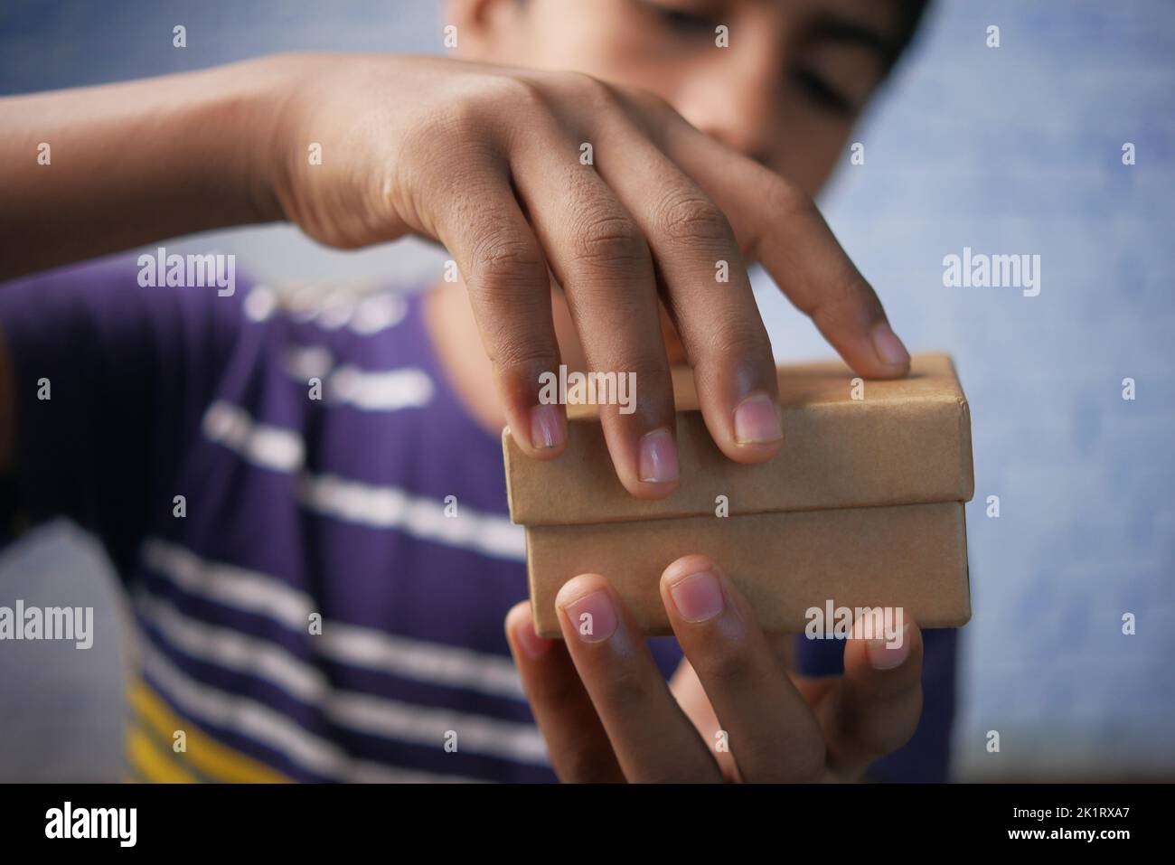 teenage boy open a empty small gift box Stock Photo - Alamy